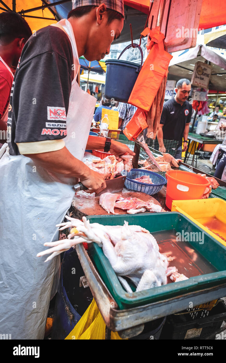 KUALA LUMPUR / MALAYSIA / JUNE 2014: Selling meat in the Pudu street ...