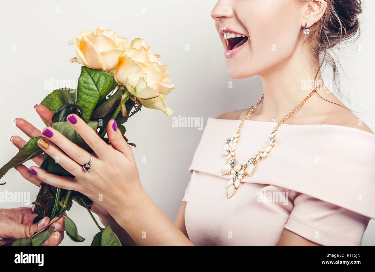 Man is giving beautiful roses to his excited girlfriend. Happy women's ...