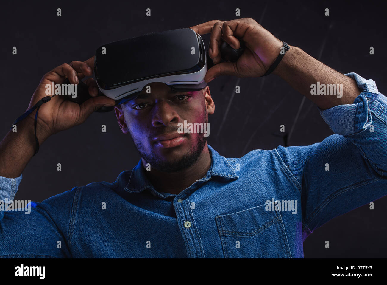 African male architector taking off his virtual reality headset looking ...