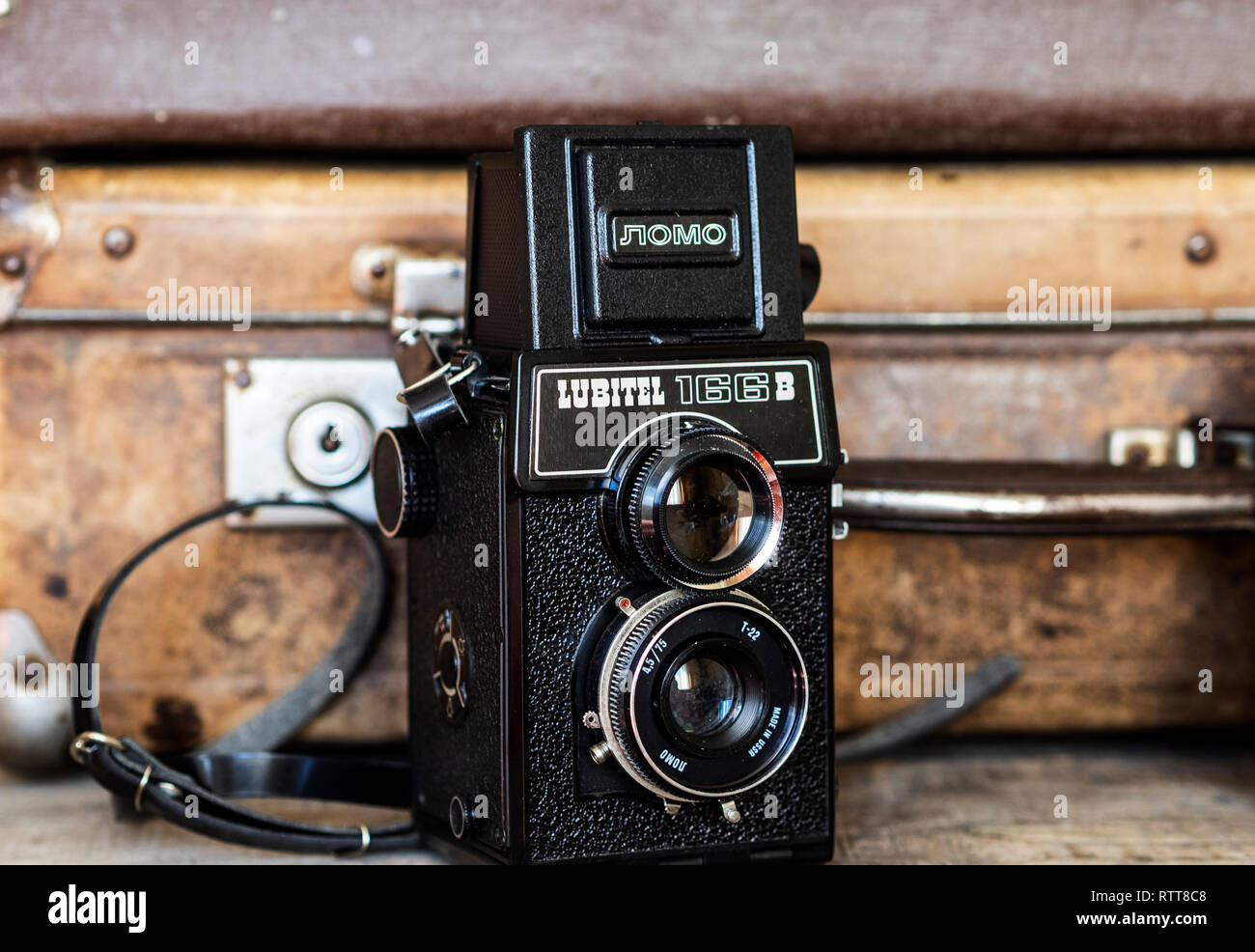 Old roll film camera on the background of vintage suitcase Stock Photo ...