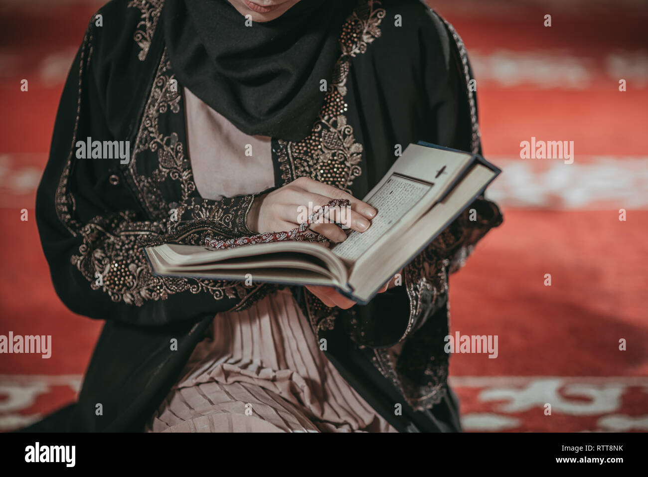 Young beautiful girl reading a holy book of muslim Quran Stock Photo ...