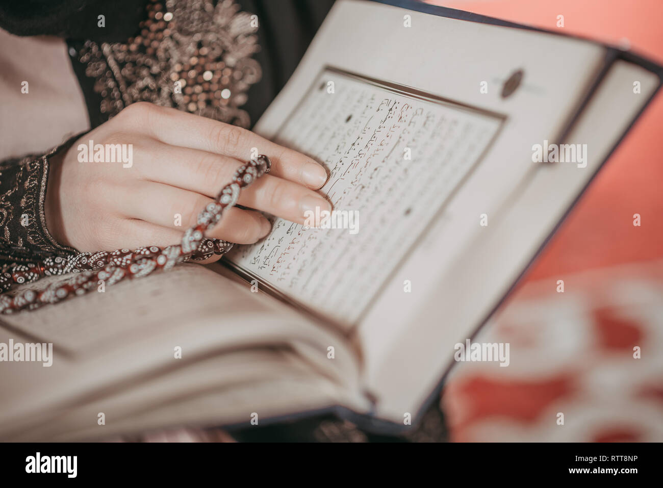 Young beautiful girl reading a holy book of muslim Quran Stock Photo ...