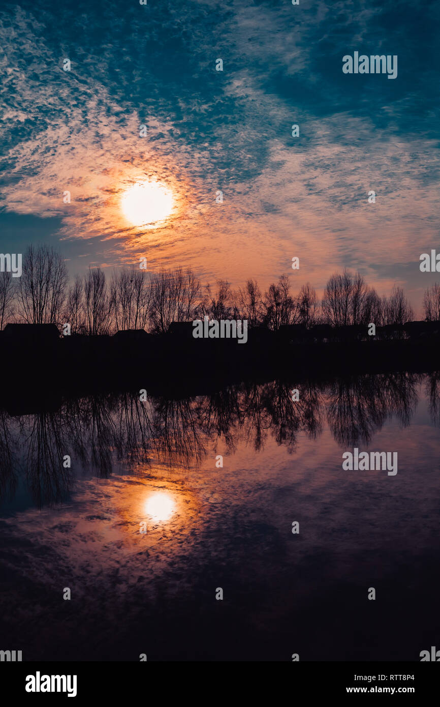 Sunset over water Stock Photo - Alamy