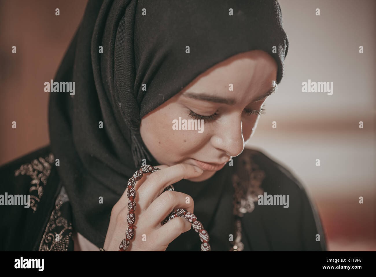 Young beautiful girl reading a holy book of muslim Quran Stock Photo ...