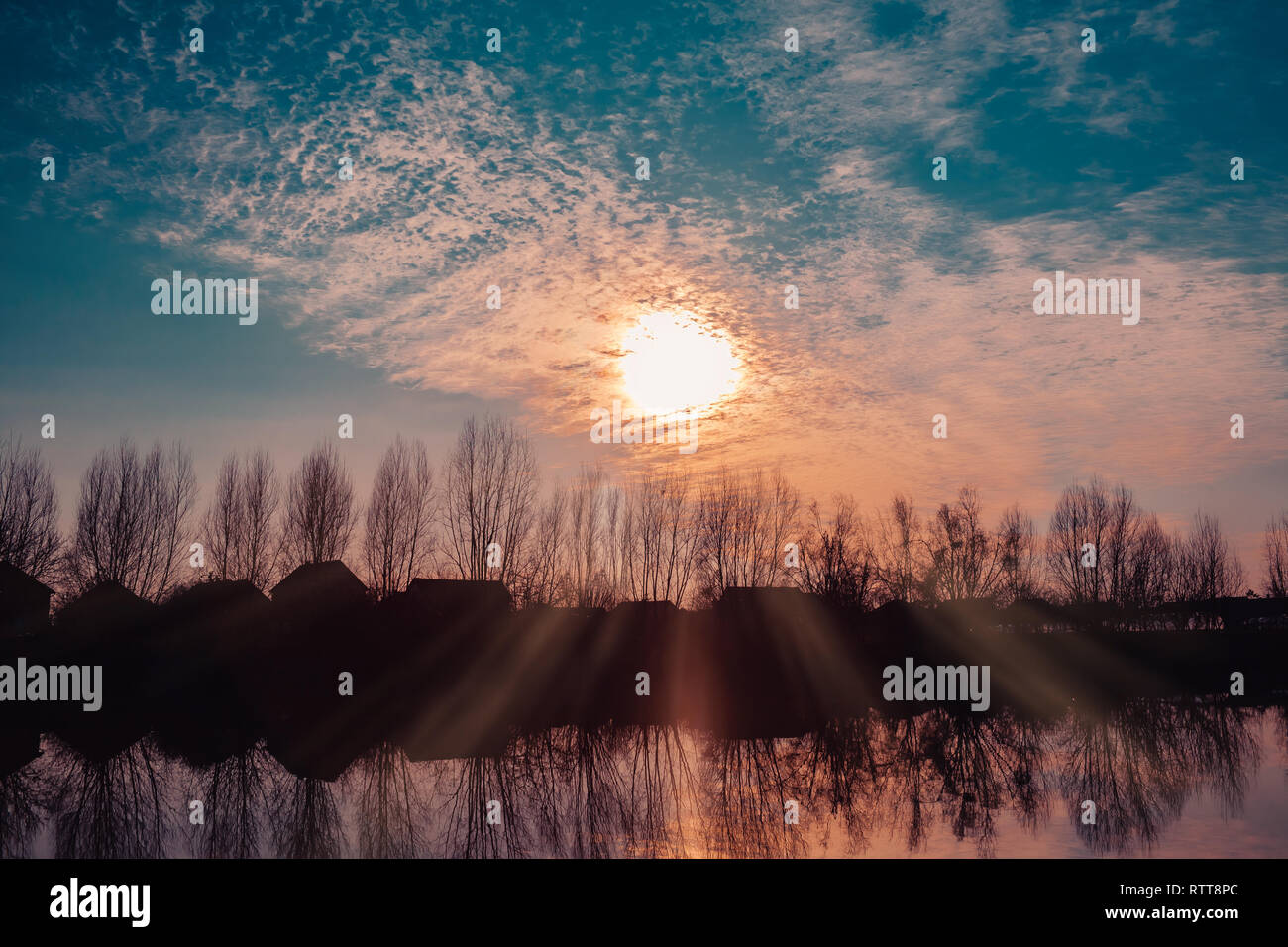 Sunset over water Stock Photo - Alamy