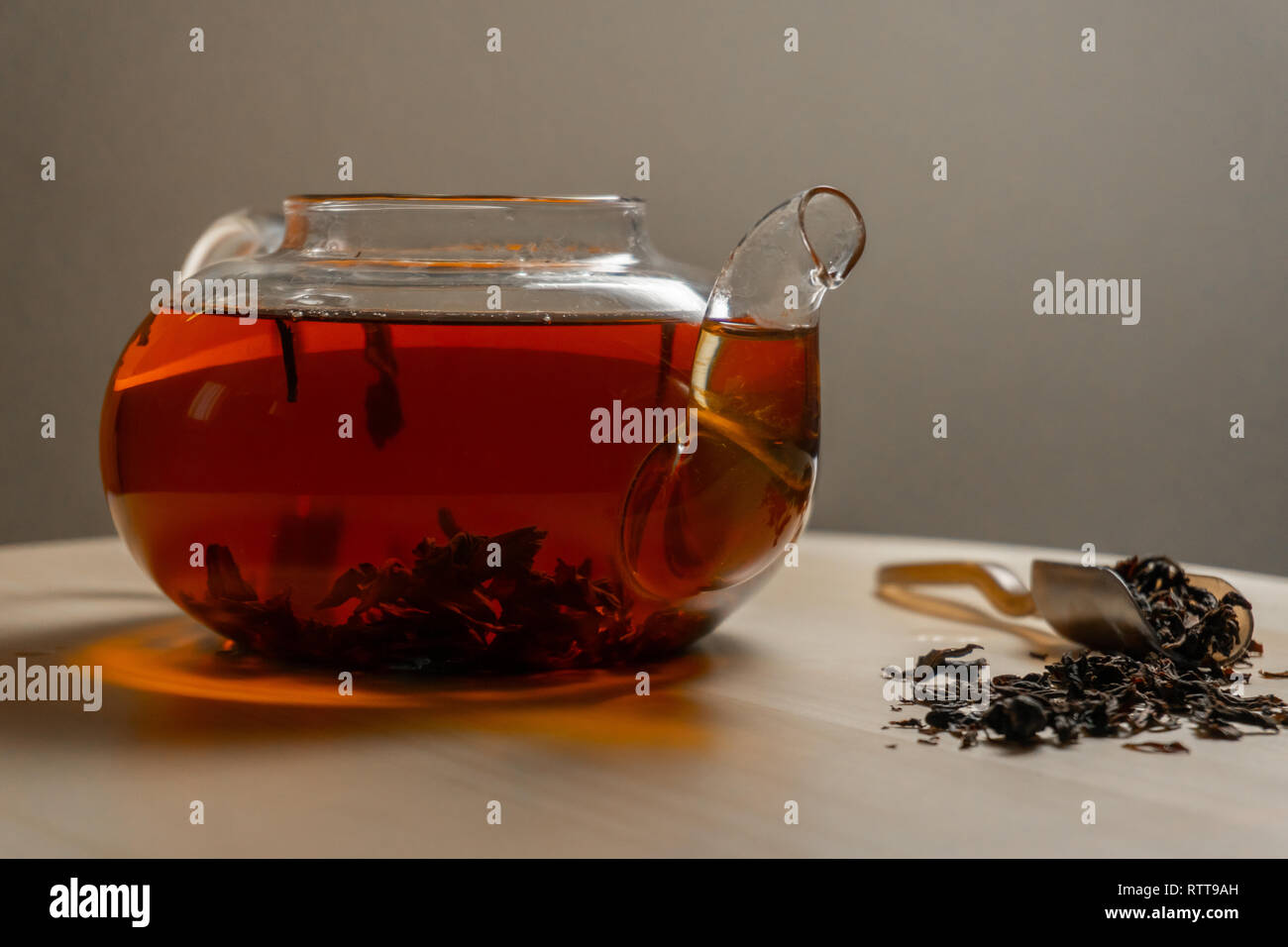 Teapot full of black brewed tea, side view. Fresh and tasty hot tea ...