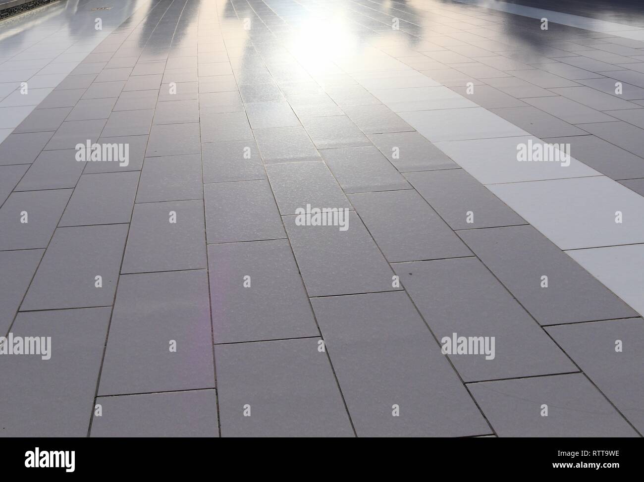 Diffuse reflections of pedestrians walking a marble sidewalk in dubai ...