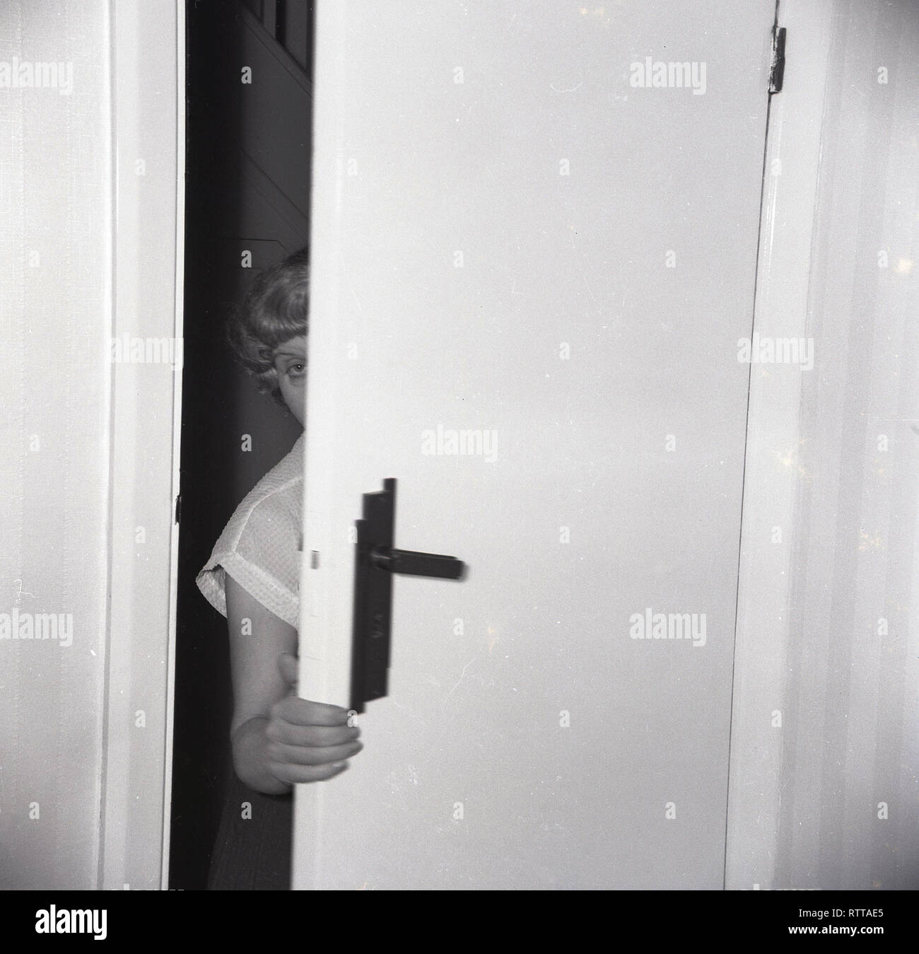 1950s, lady behind a door Stock Photo - Alamy