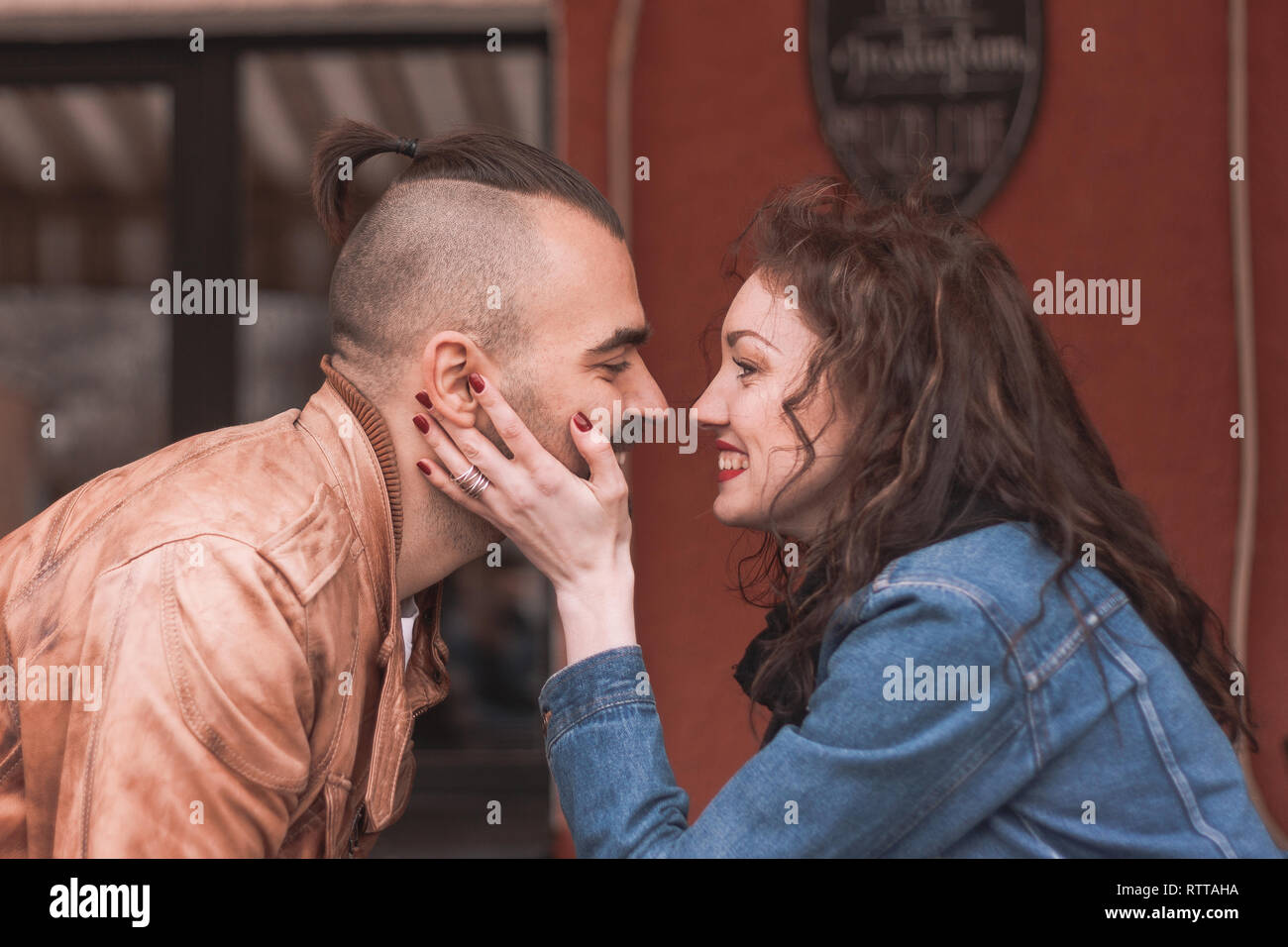 happy couple in love kissing sitting at a table in a city cafe Stock ...