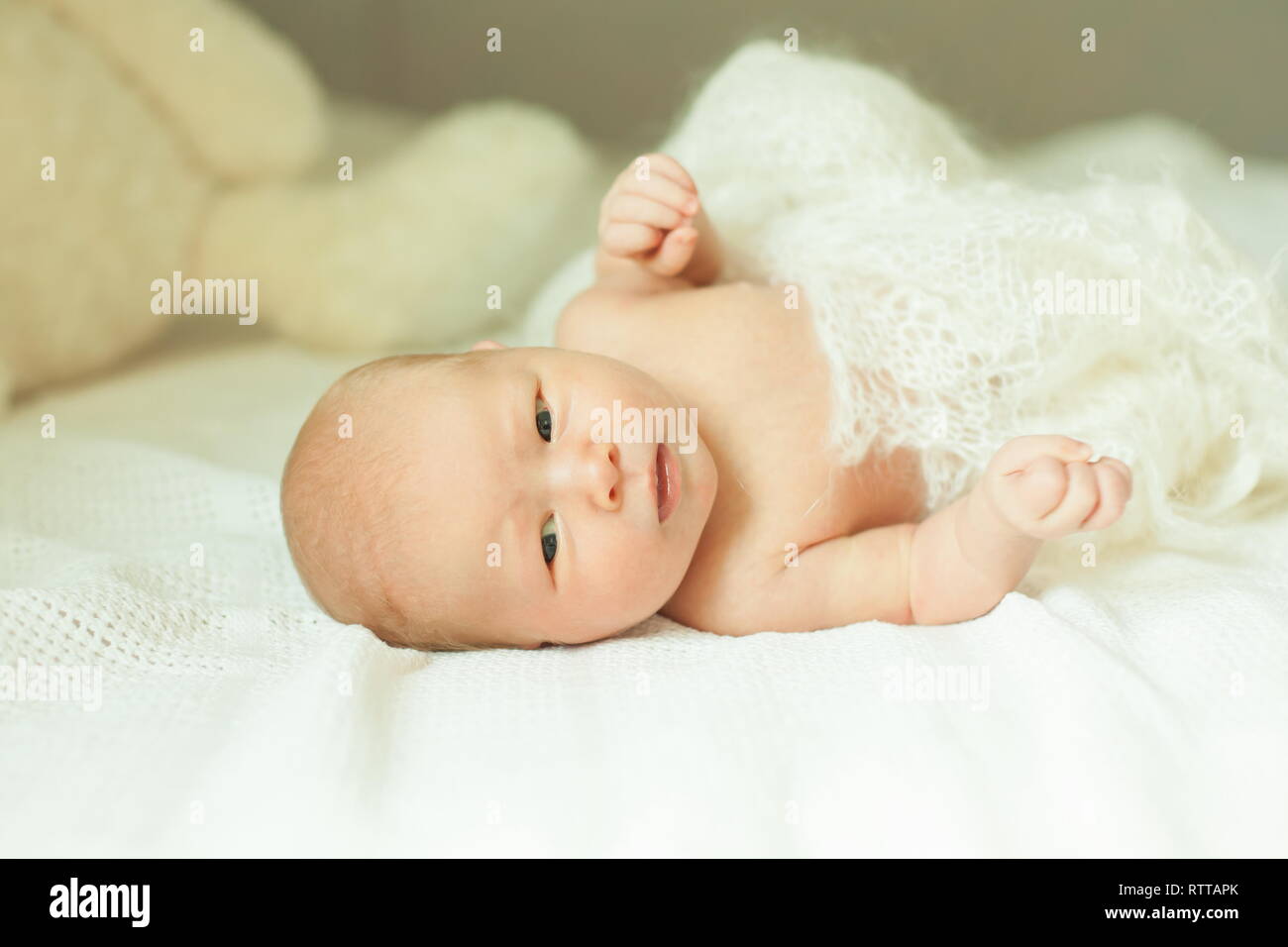 newborn baby girl in a beautiful bonnet lying on a blanket Stock Photo ...