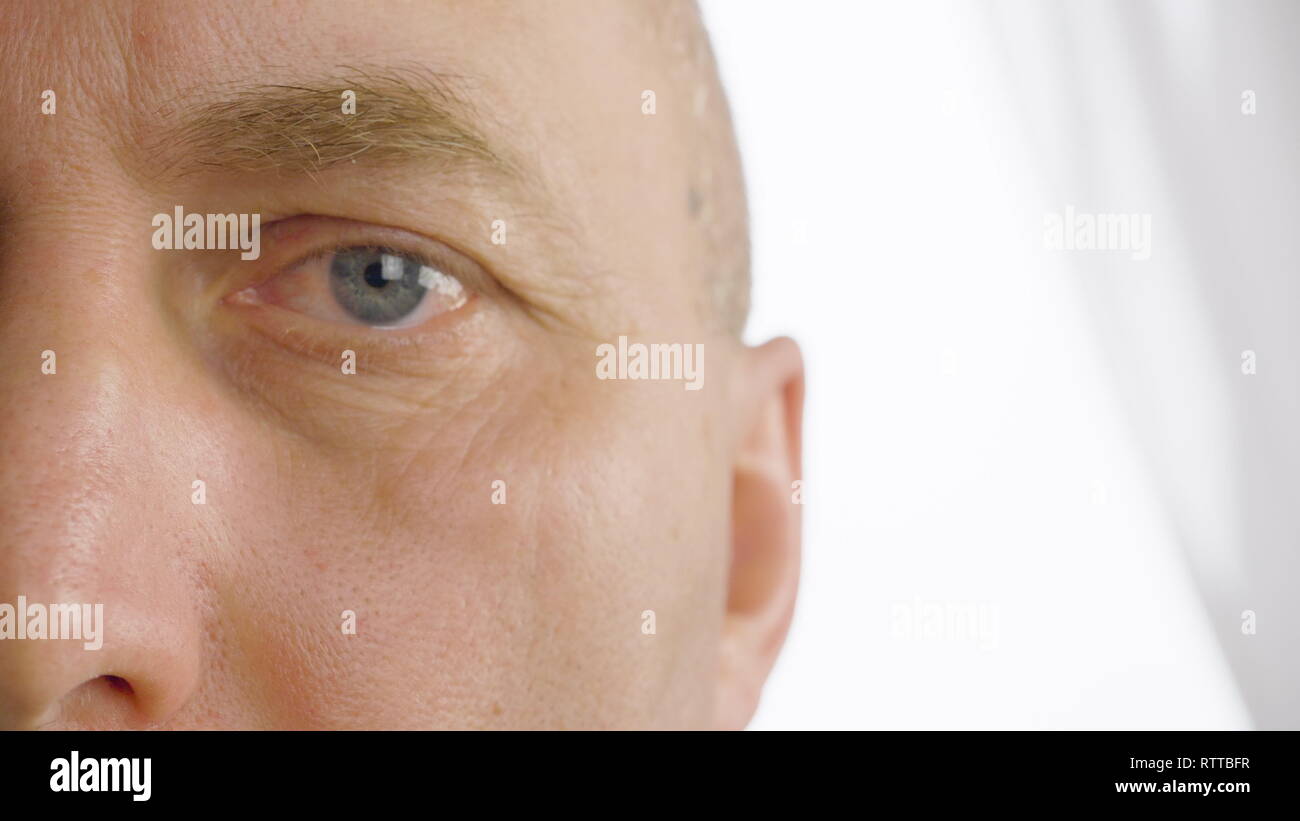 Man eye close up. Macro view man's eye winking. Half of face Stock ...