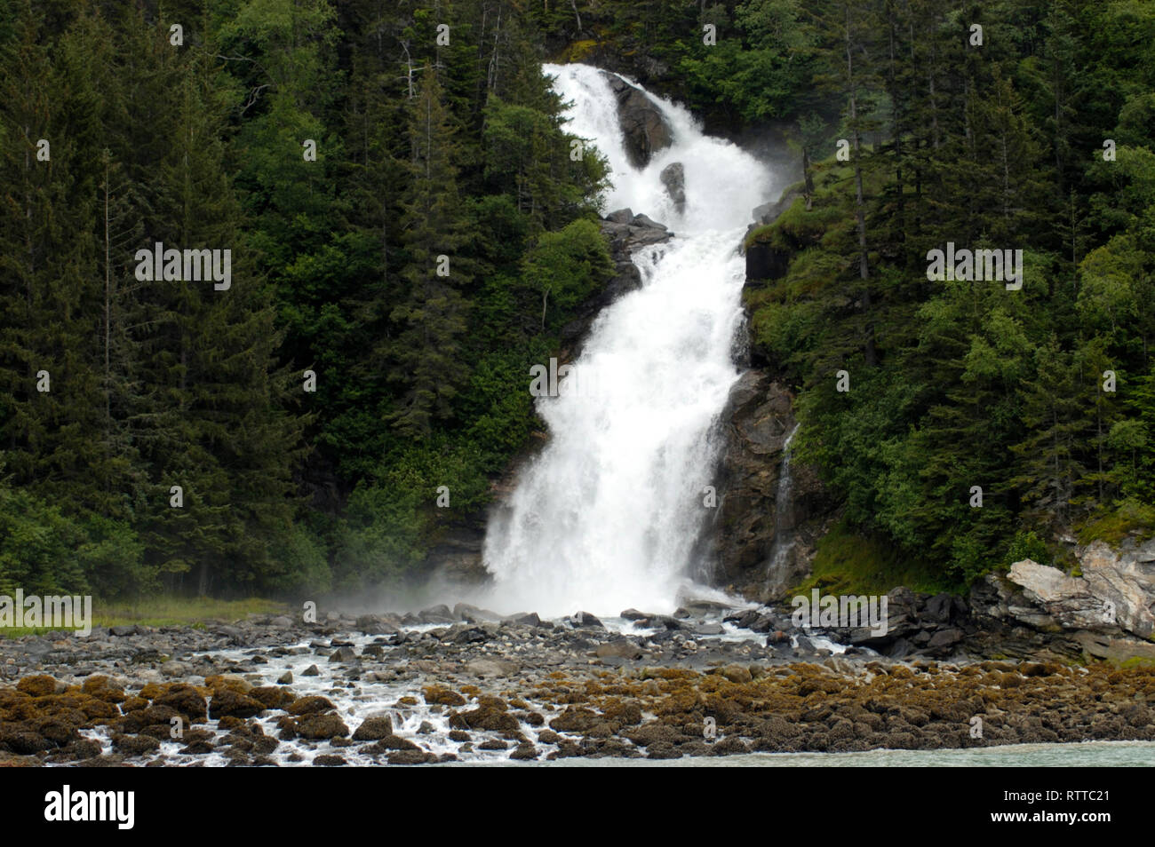 A waterfall at Tiaya Inlet near Haines, Alaska is one of Driftwood ...