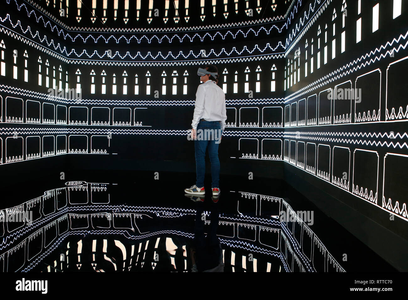 A man checks VR experience inside Saudi Telecom Company (STC) booth at ...