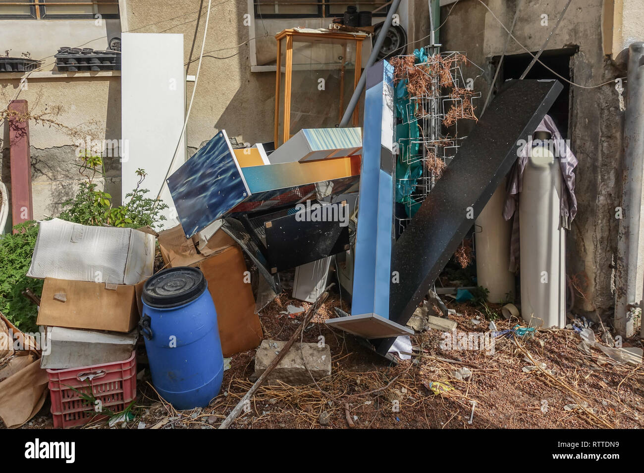Large collection of rubbish thrown into a corner. Contains cylinders ...