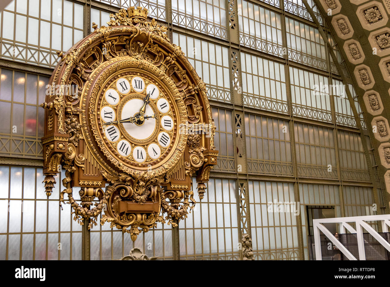 A large Gold wall clock hanging on the wall at Musée d'Orsay ,a famous ...