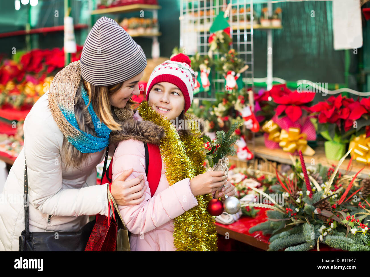 happy english woman with daughter looking at floral decoration at ...