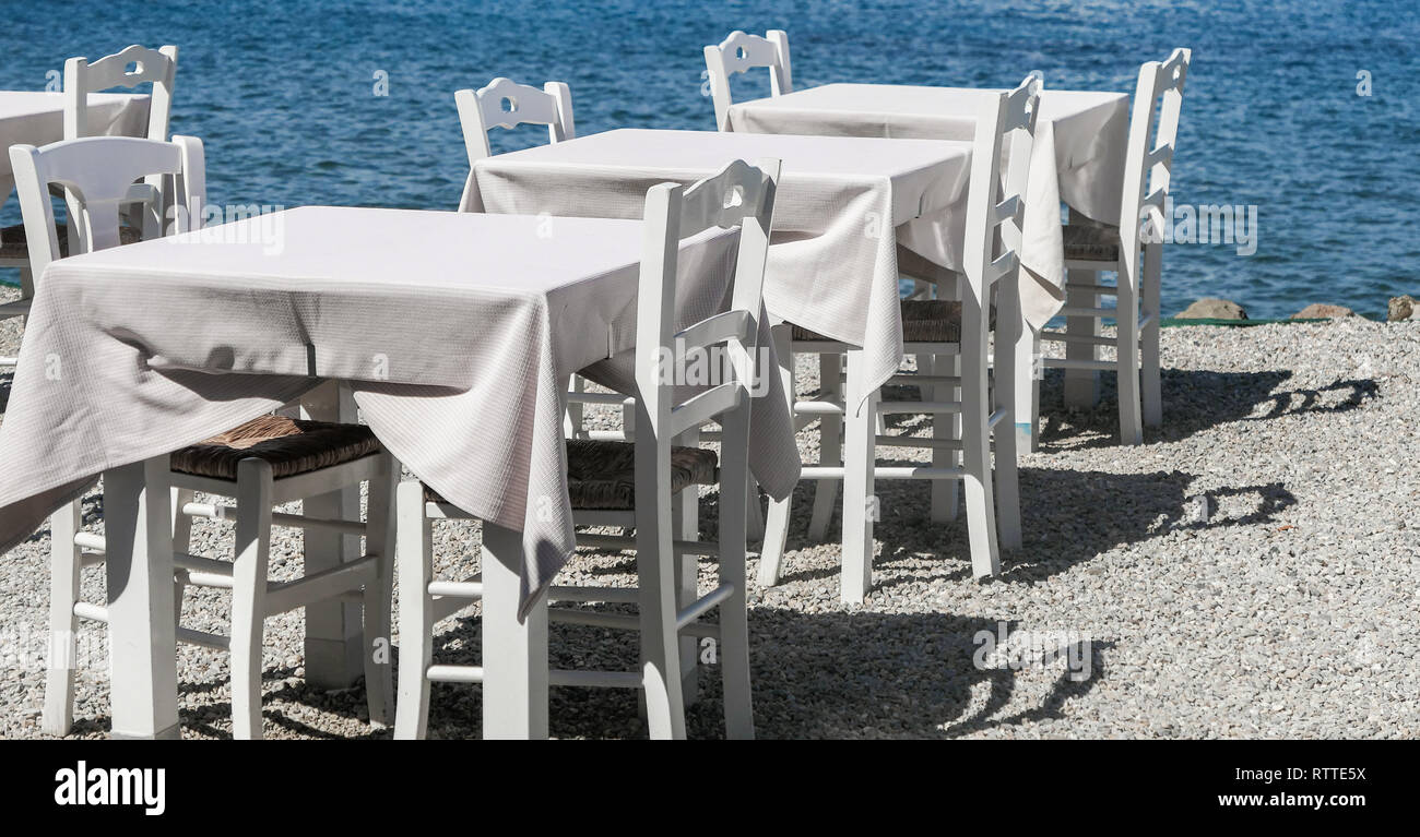 White restaurant tables on the beach in summer - travel, vacation and ...
