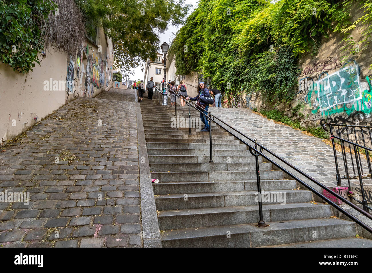 People climbing the steep steps at Rue du Calvaire, which connects Rue ...