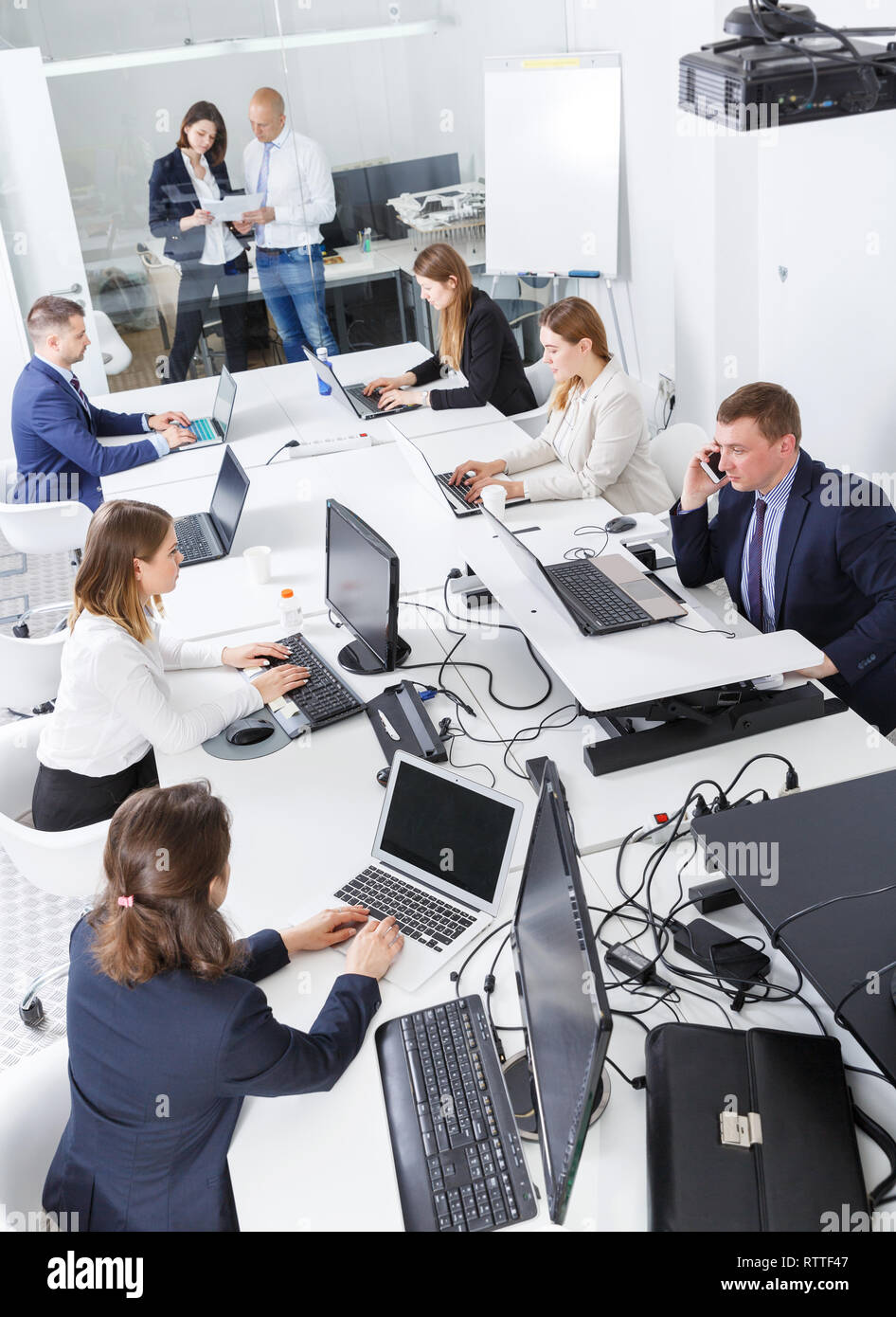 Above view of group of serious business people during daily work in ...