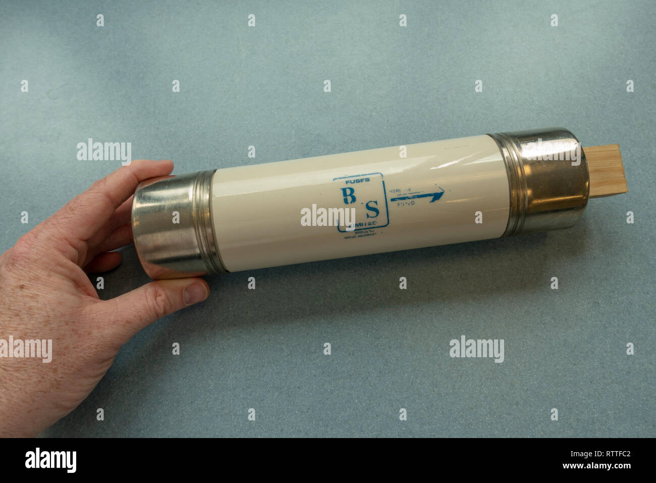 Aman holding a massive fuse as used in the power generation and ...