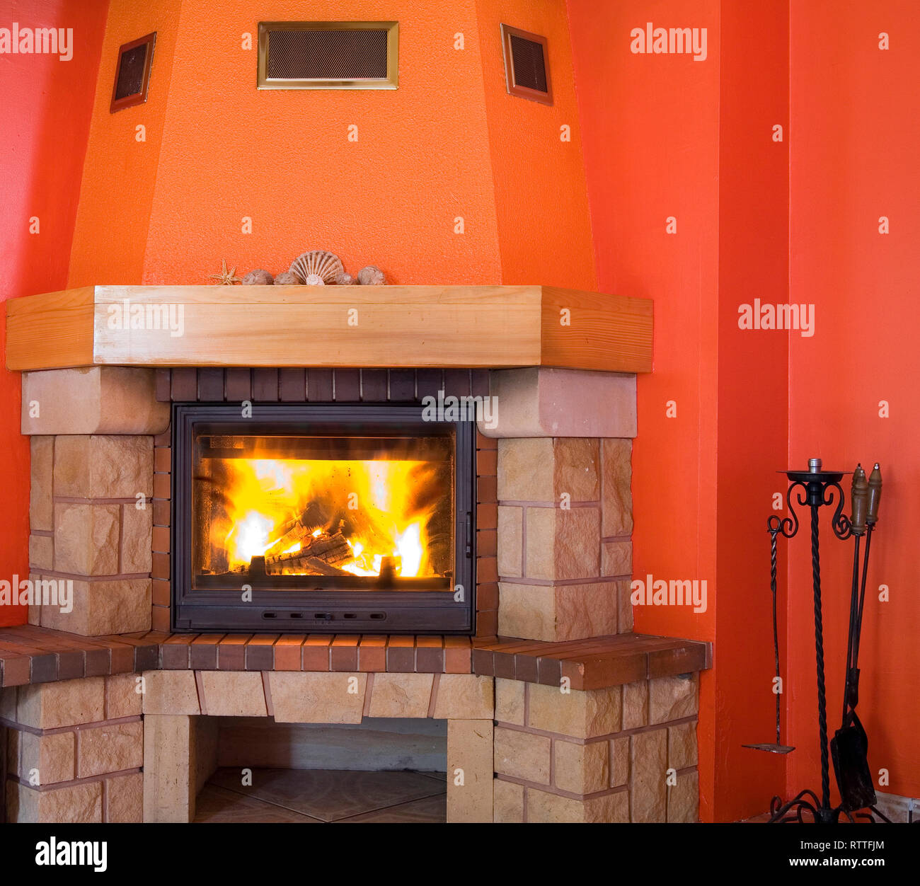 red fireplace with a small hell inside Stock Photo - Alamy