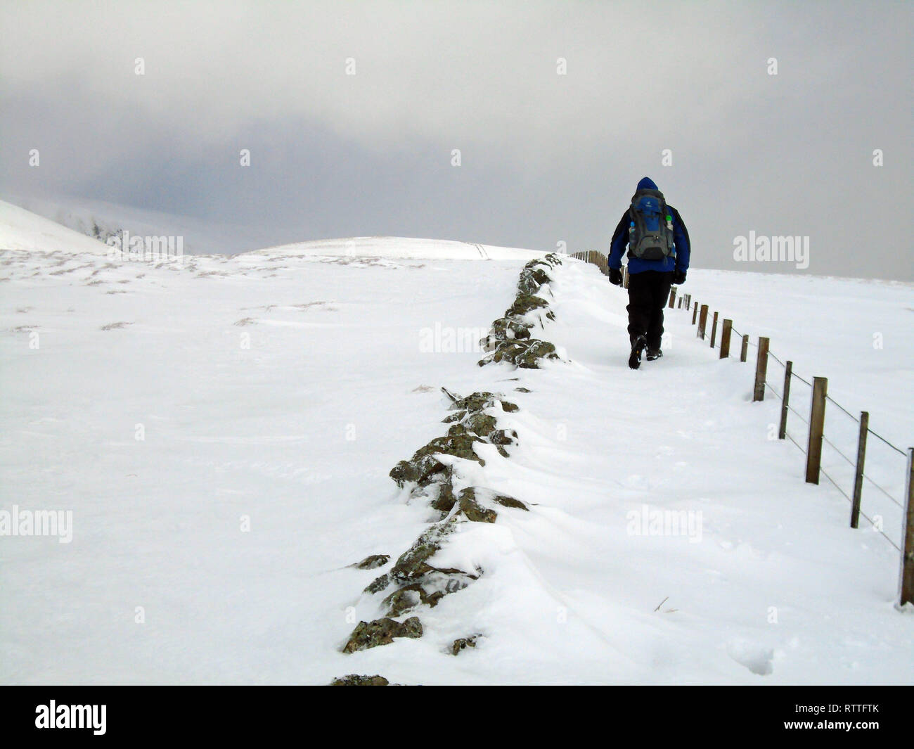 Lone Male Hiker Walking in Snow on Route to the Scottish Mountain ...