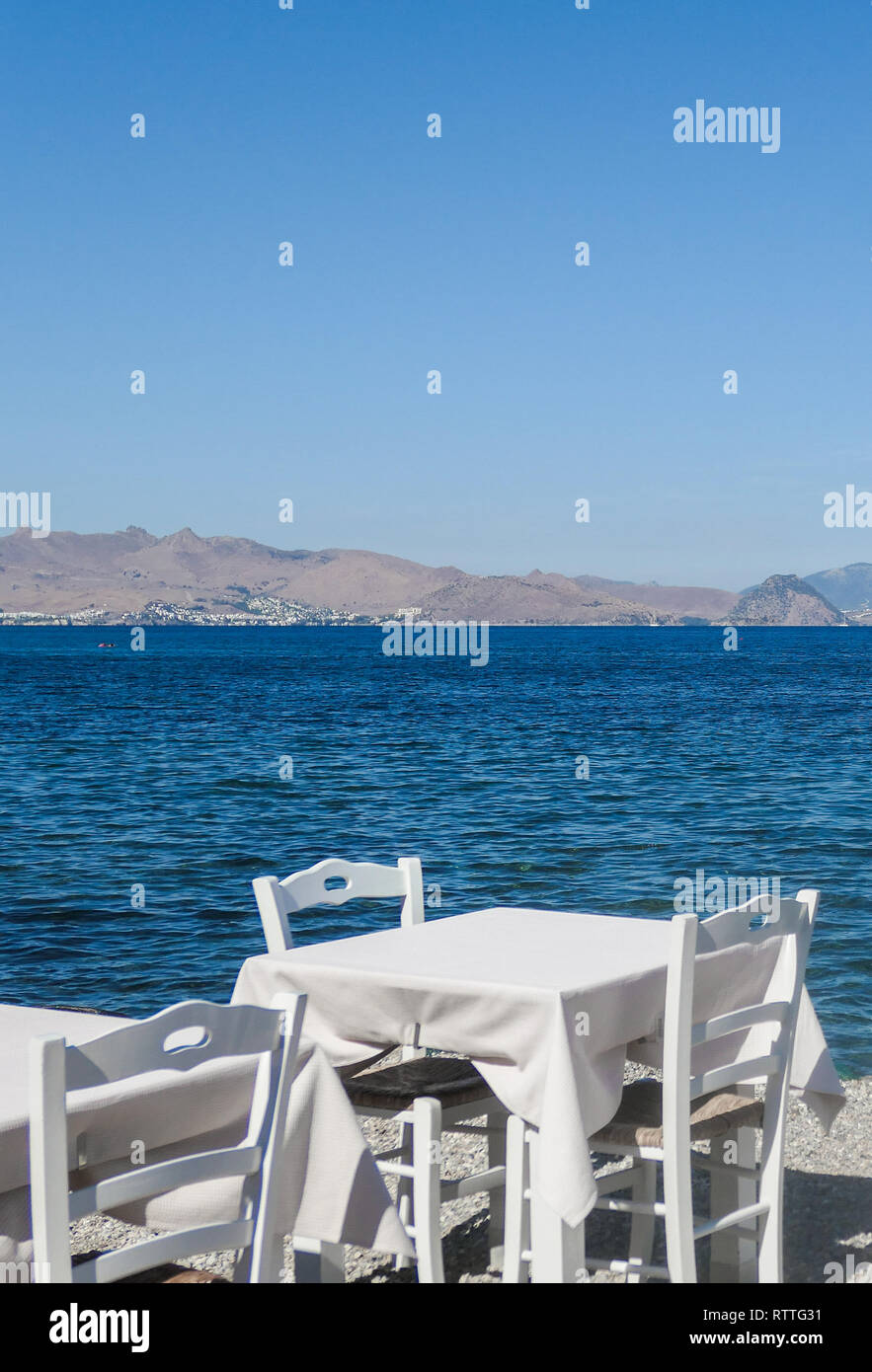 White restaurant tables on the beach in summer - travel, vacation and ...