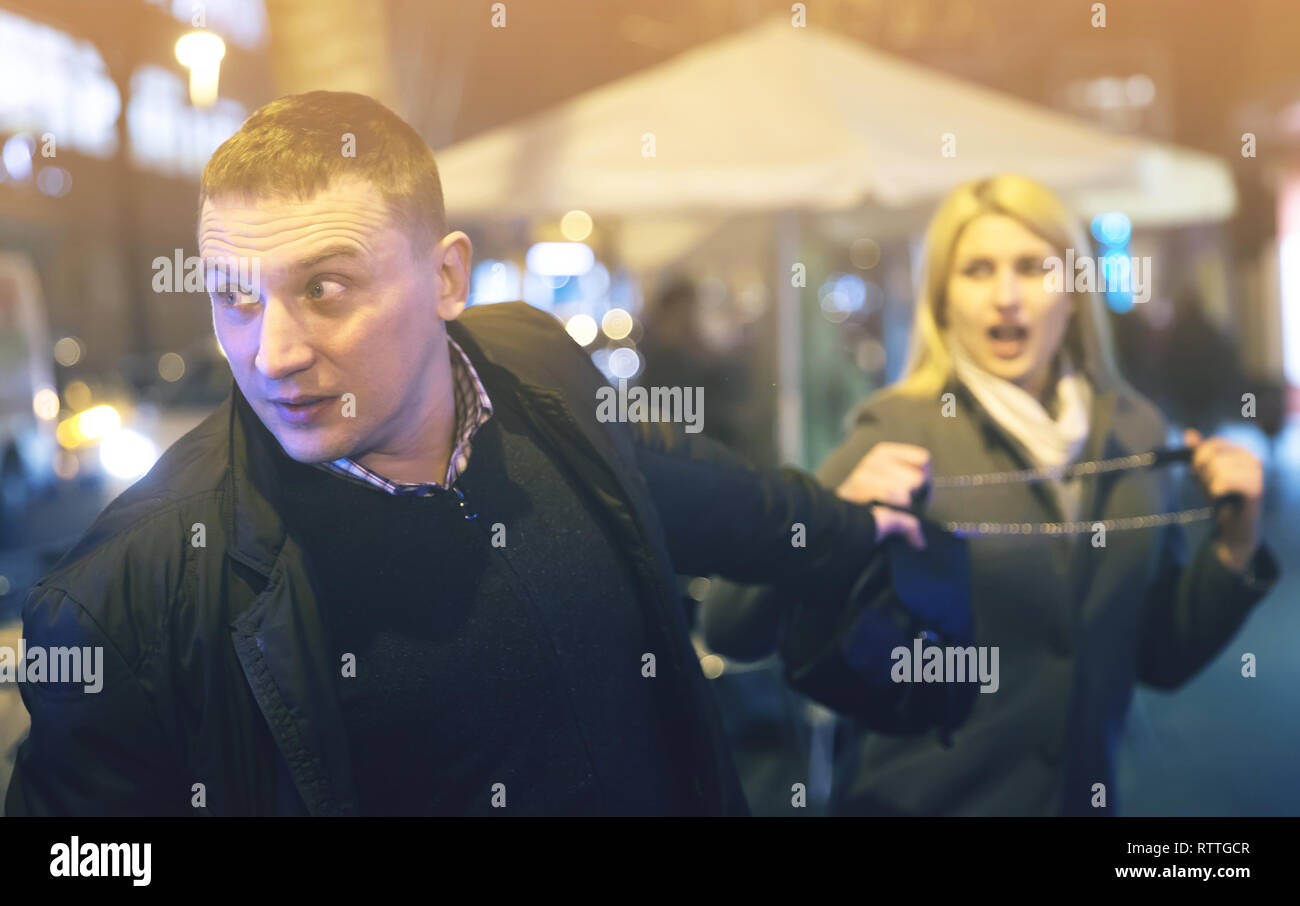 Angry aggressive adult man is stole the handbag from stranger girl on ...