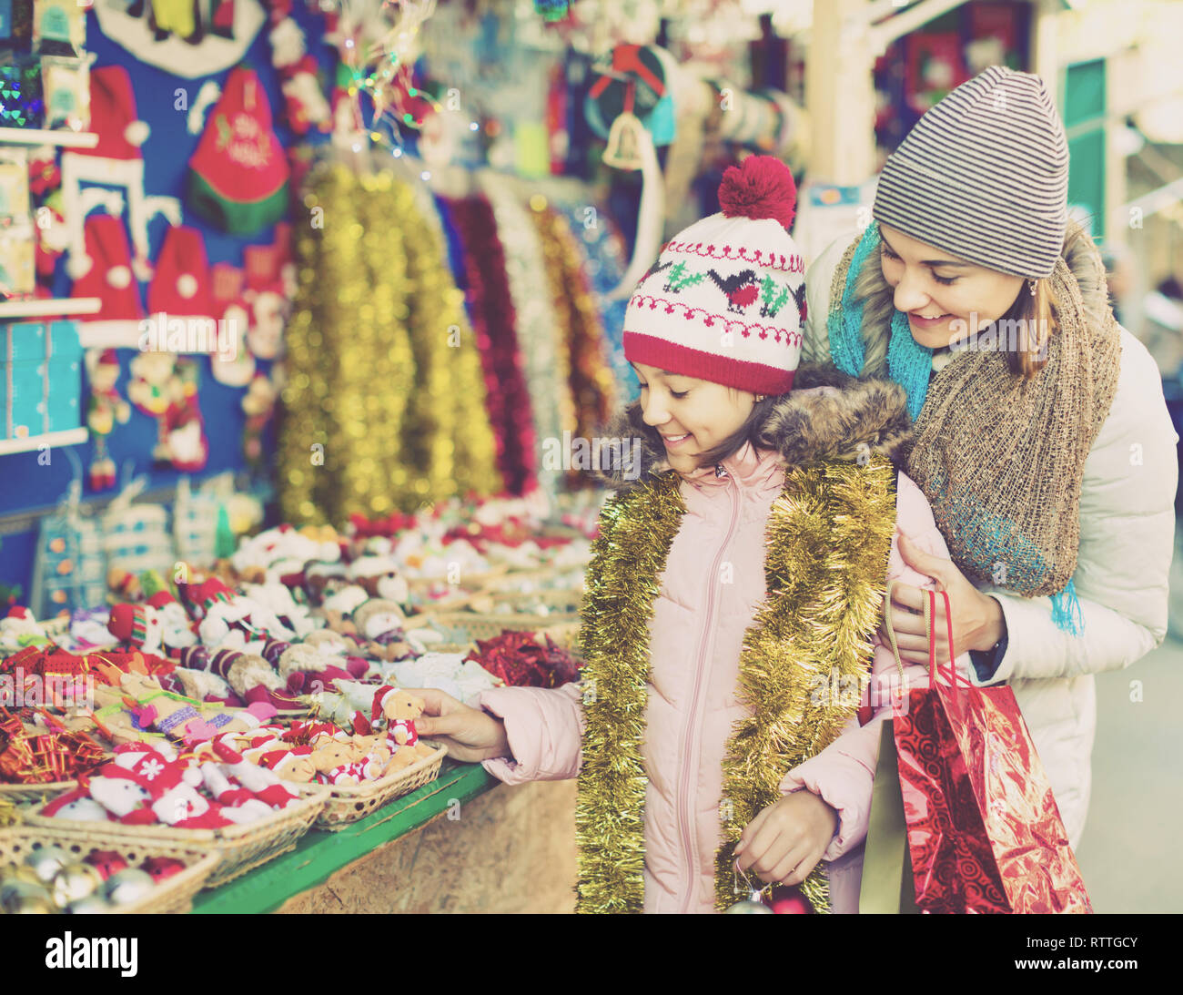 Satisfied pleasant smiling female customers staring at counter of ...