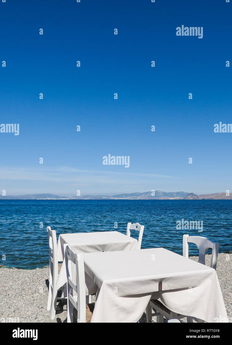 White restaurant tables on the beach in summer - travel, vacation and ...