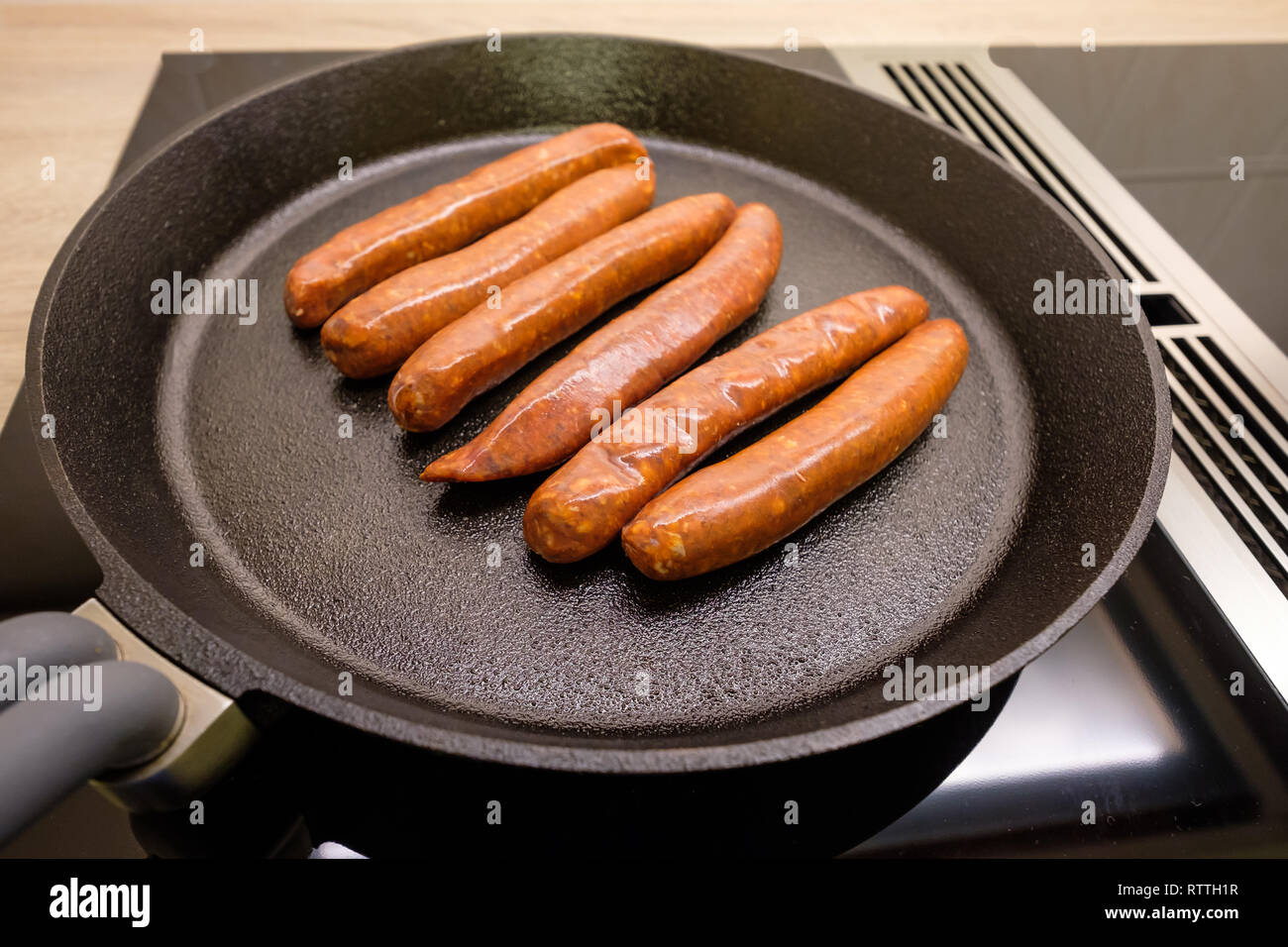 Merguez sausages of lamb and beef in a iron cast frying pan Stock Photo ...