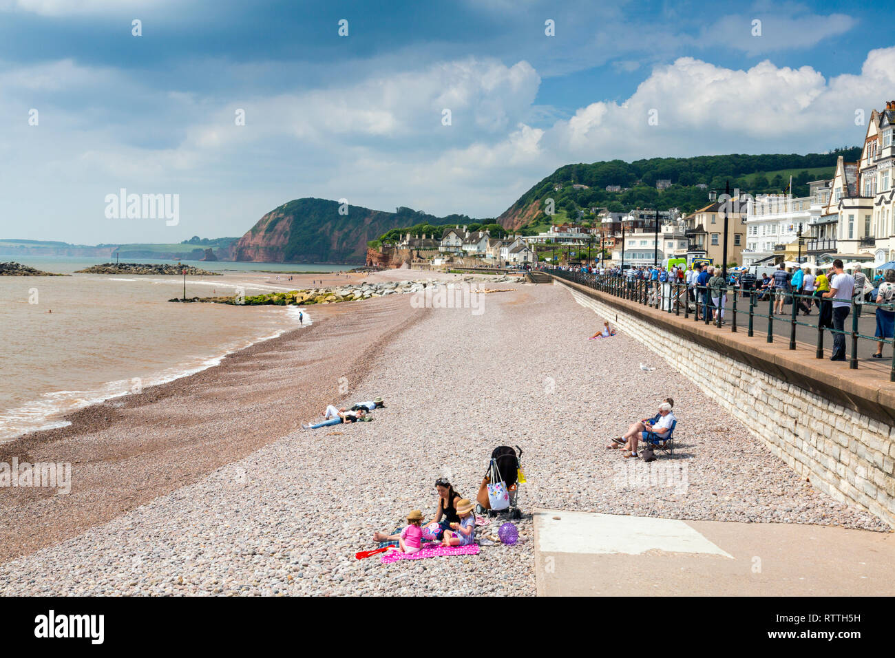 Looking west along the Jurassic Coast at the red sandstone cliffs ...