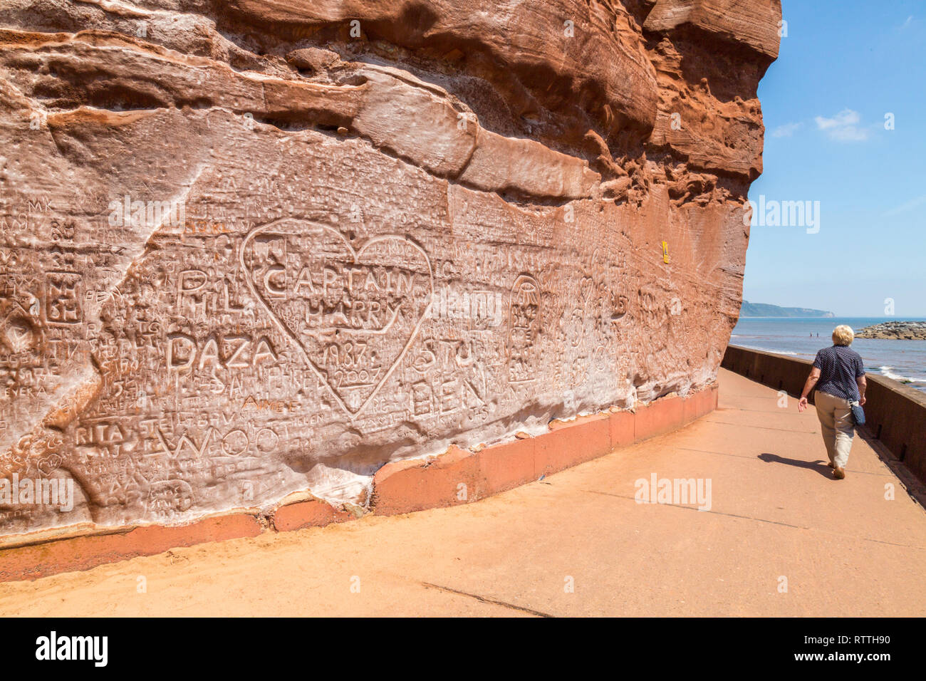 Modern rock carvings graffiti in the red sandstone on the undercliff ...