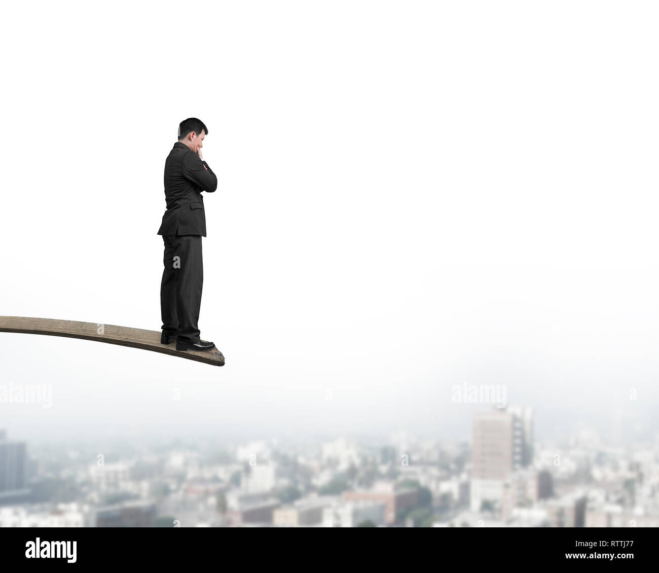 Thinking businessman standing on springboard with cityscape background ...