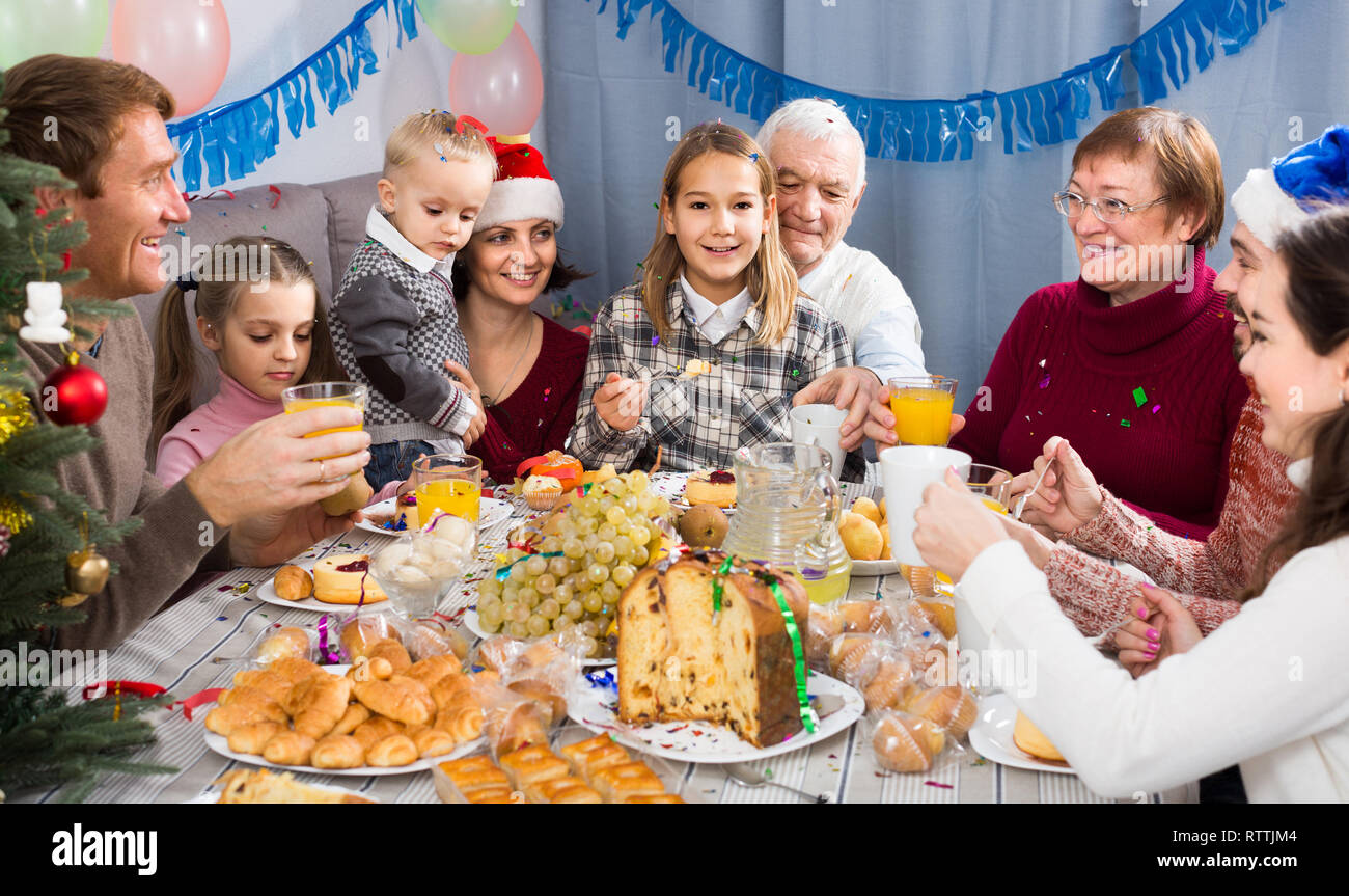 Large happy family talking animatedly during Christmas dinner Stock ...