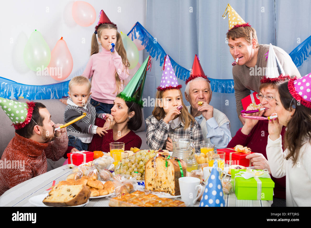 Large happy spanish family having fun during children’s birthday party ...