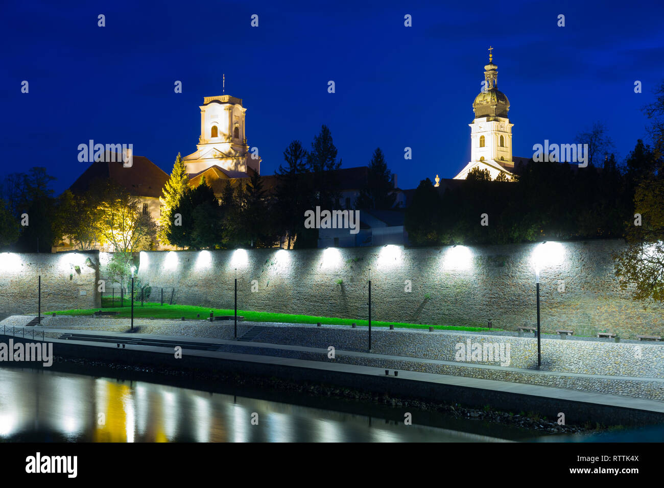 Night view of illuminated Episcopal Castle on riverside of Raba, Gyor ...