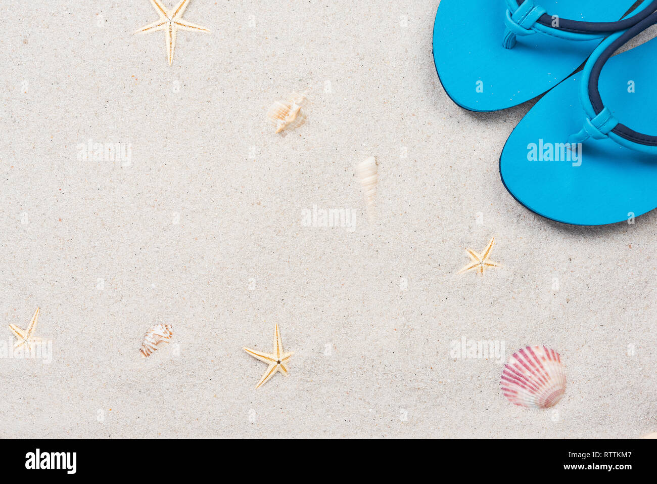 Sunbathing and summer concept, border background. Flipflops on sandy ...