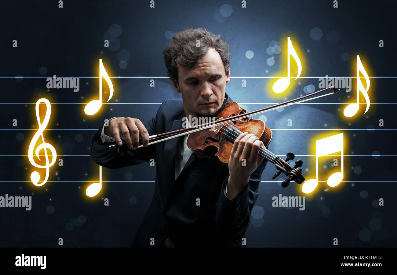 Young handsome fiddler playing with music sheet background Stock Photo ...