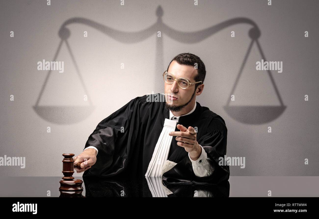 Young handsome judge in black gown making decision Stock Photo - Alamy