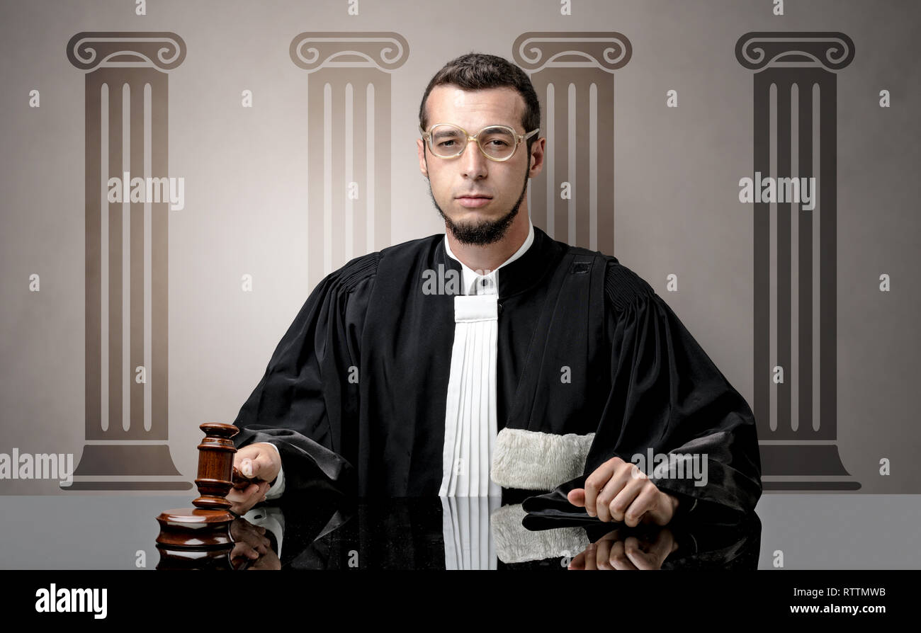 Young judge in front of a courthouse symbol making decision Stock Photo ...