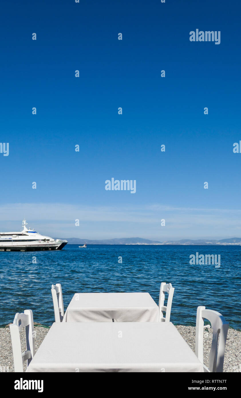 White restaurant tables on the beach in summer - travel, vacation and ...
