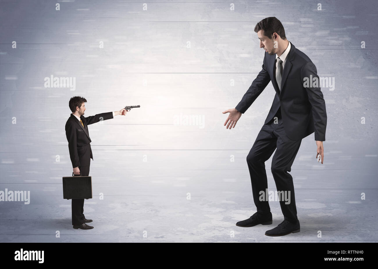 Tiny businessman with gun shooting giant fearful businessman Stock ...