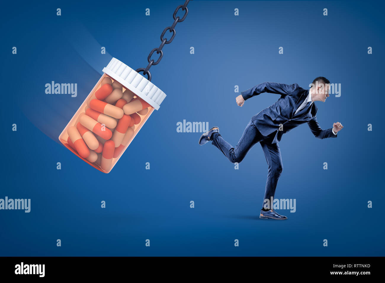 A side view of a businessman running from a huge full pills jar ...