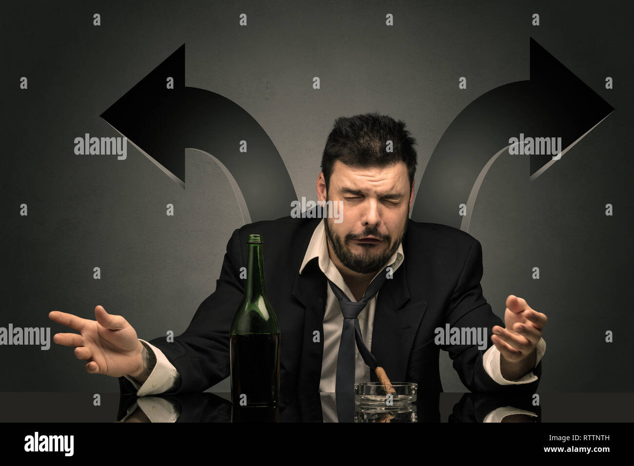 Drunk disappointed man sitting at table with arrows around Stock Photo ...