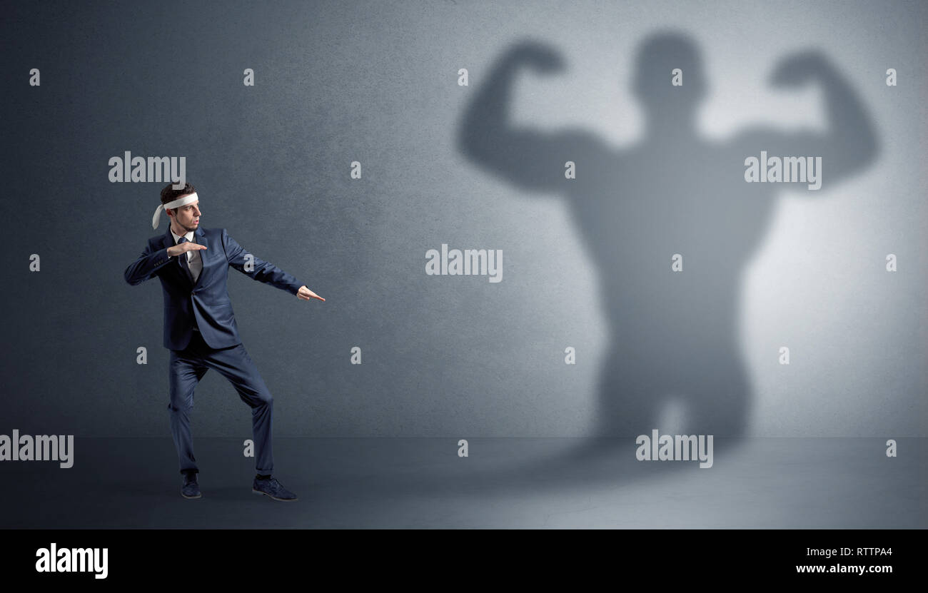 Young karate man fighting with a big black scary shadow Stock Photo - Alamy