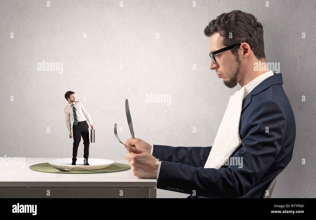 Tiny scared weak businessman almost devoured by great power Stock Photo ...