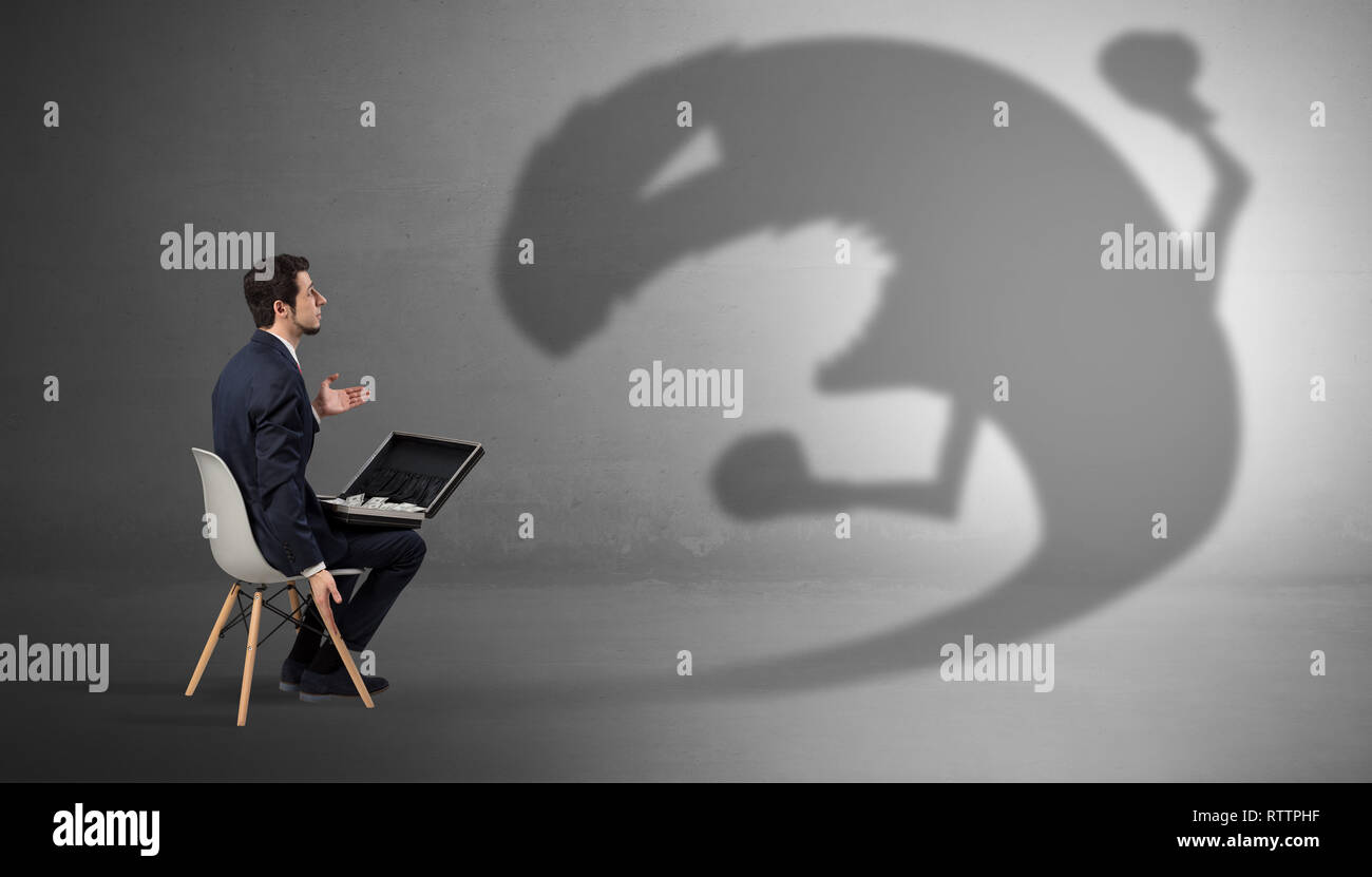 Young businessman staying and negotiate with a monster shadow Stock ...