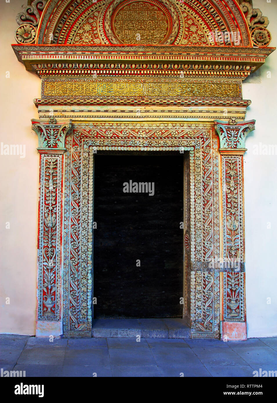 Front gate of the medieval eastern palace with metal doors and stone ...