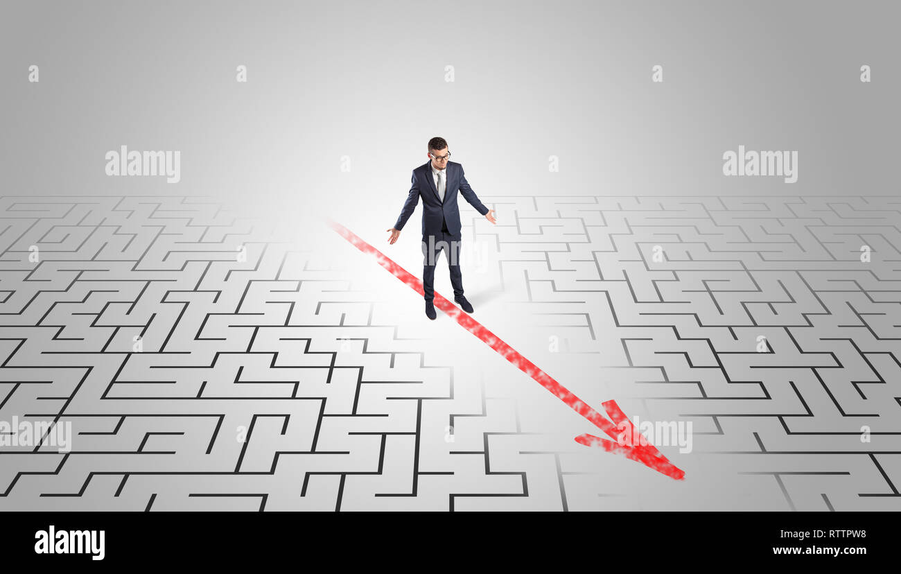 Businessman going through the maze with red arrow Stock Photo - Alamy